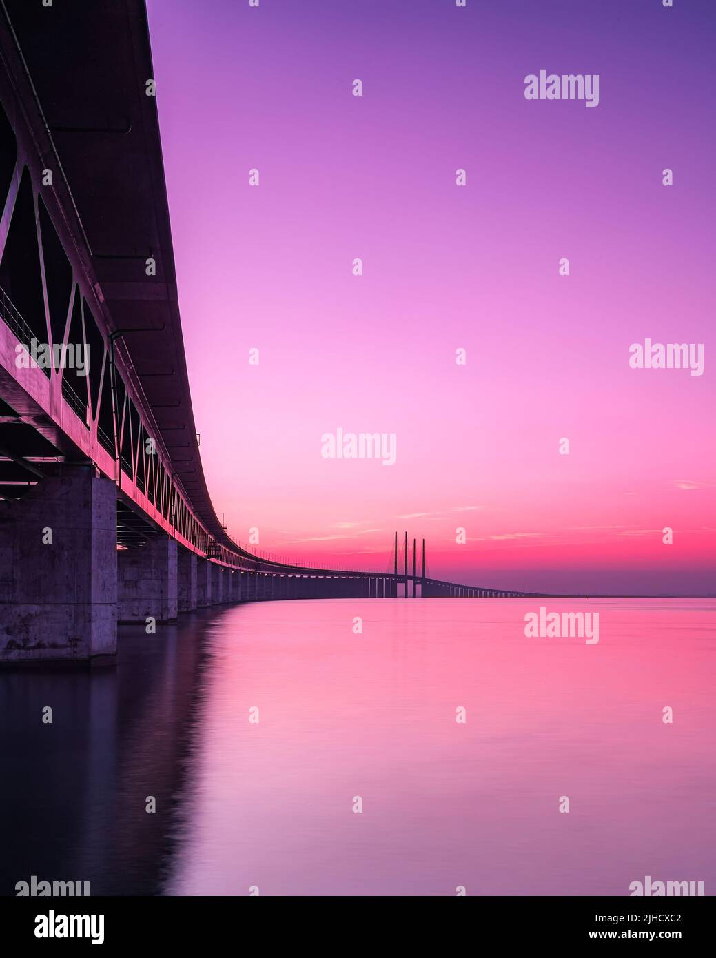A vertical shot of a bridge above a lake captured during a mesmerizing ...