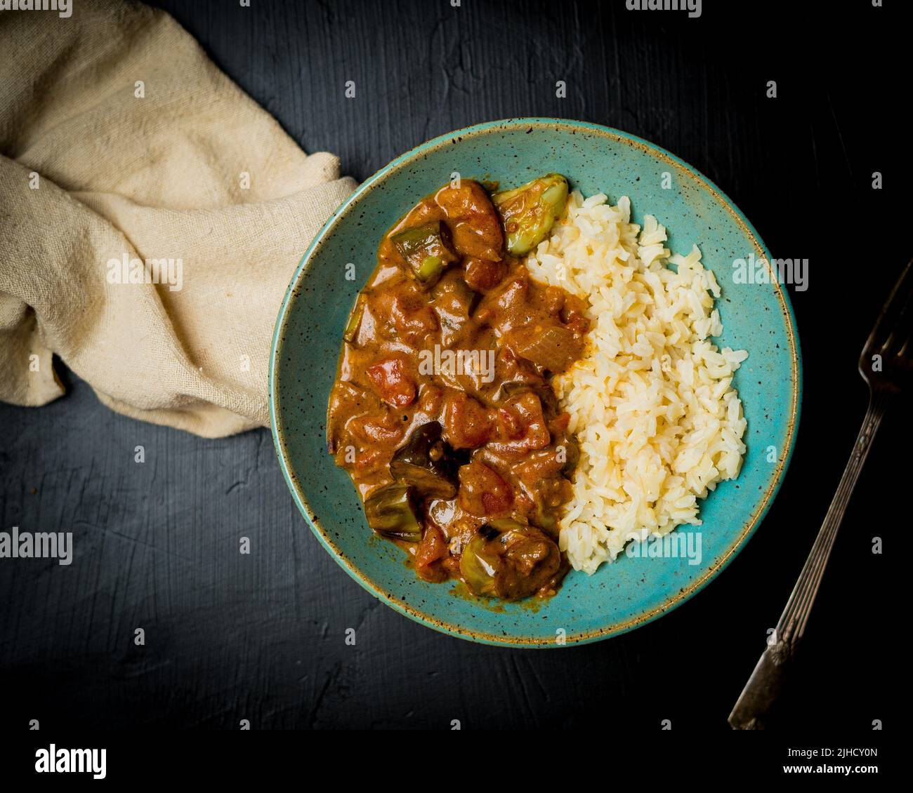 Eggplant curry with brown rice Stock Photo - Alamy