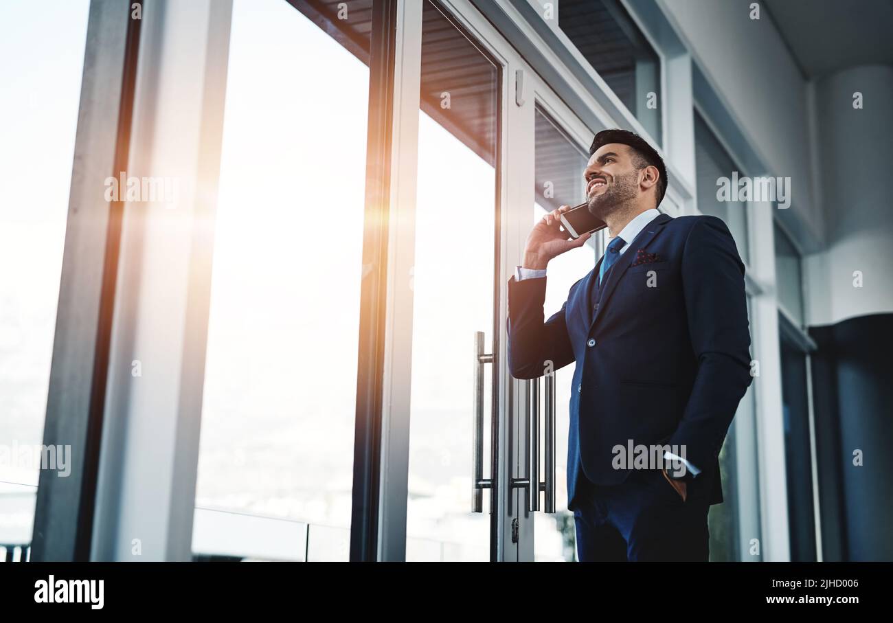 Taking one call at a time in the corporate world. a handsome male ...