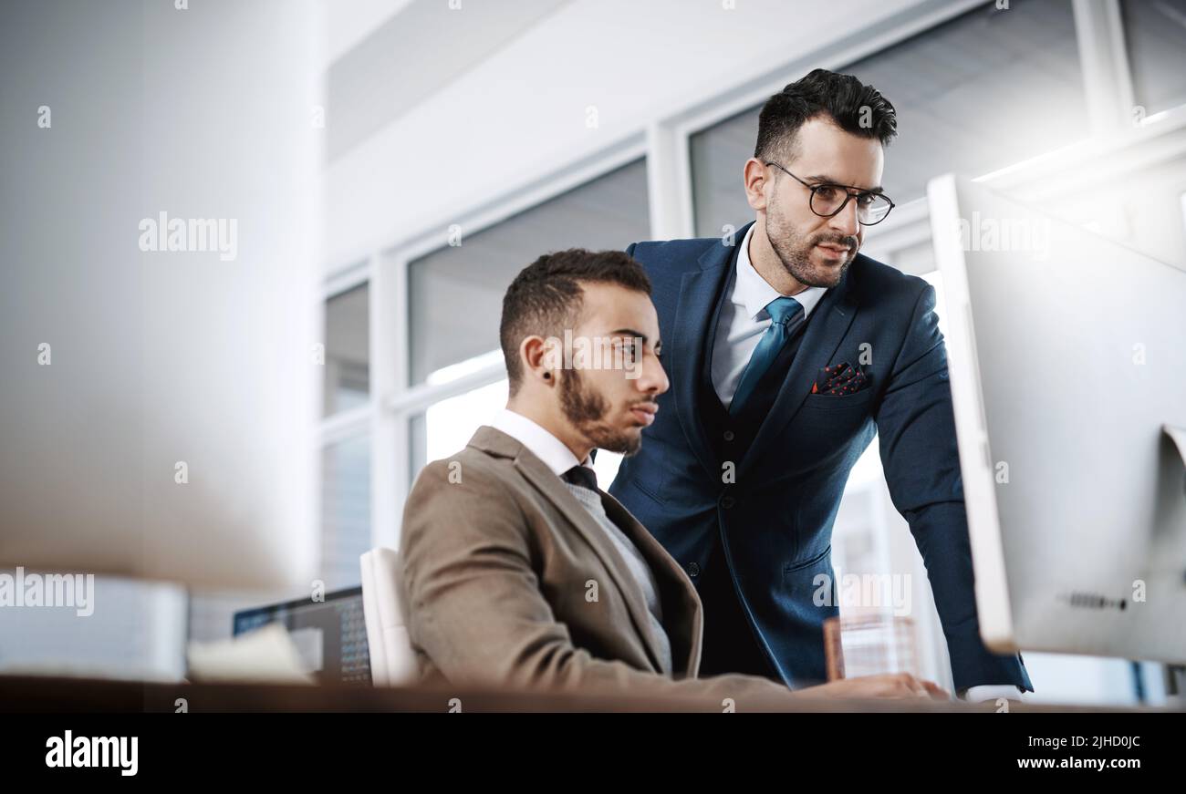 This issue requires teamwork to solve. two businessmen working together ...