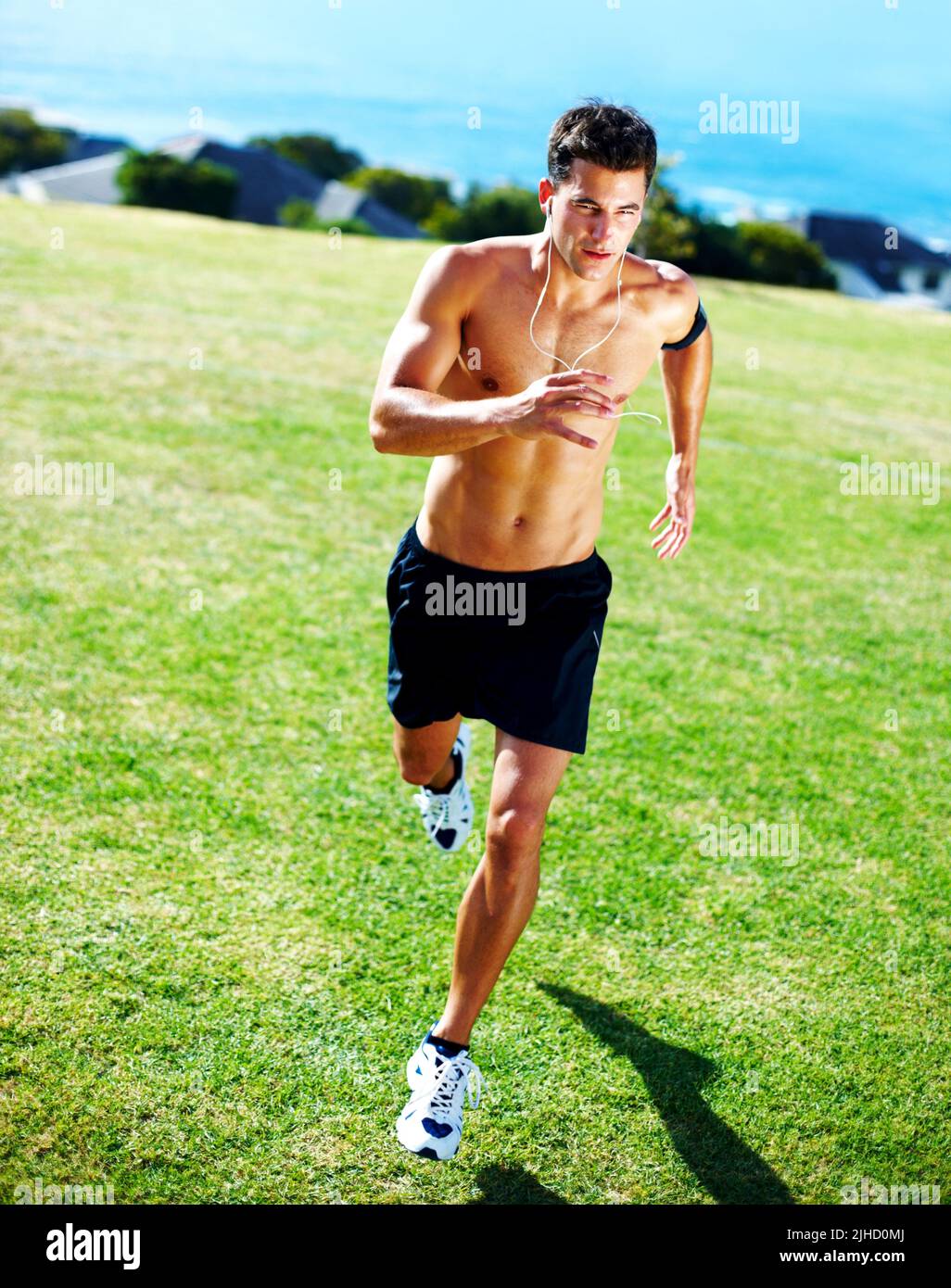 Young masculine man running on the grass - Outdoor. Portrait of a young ...