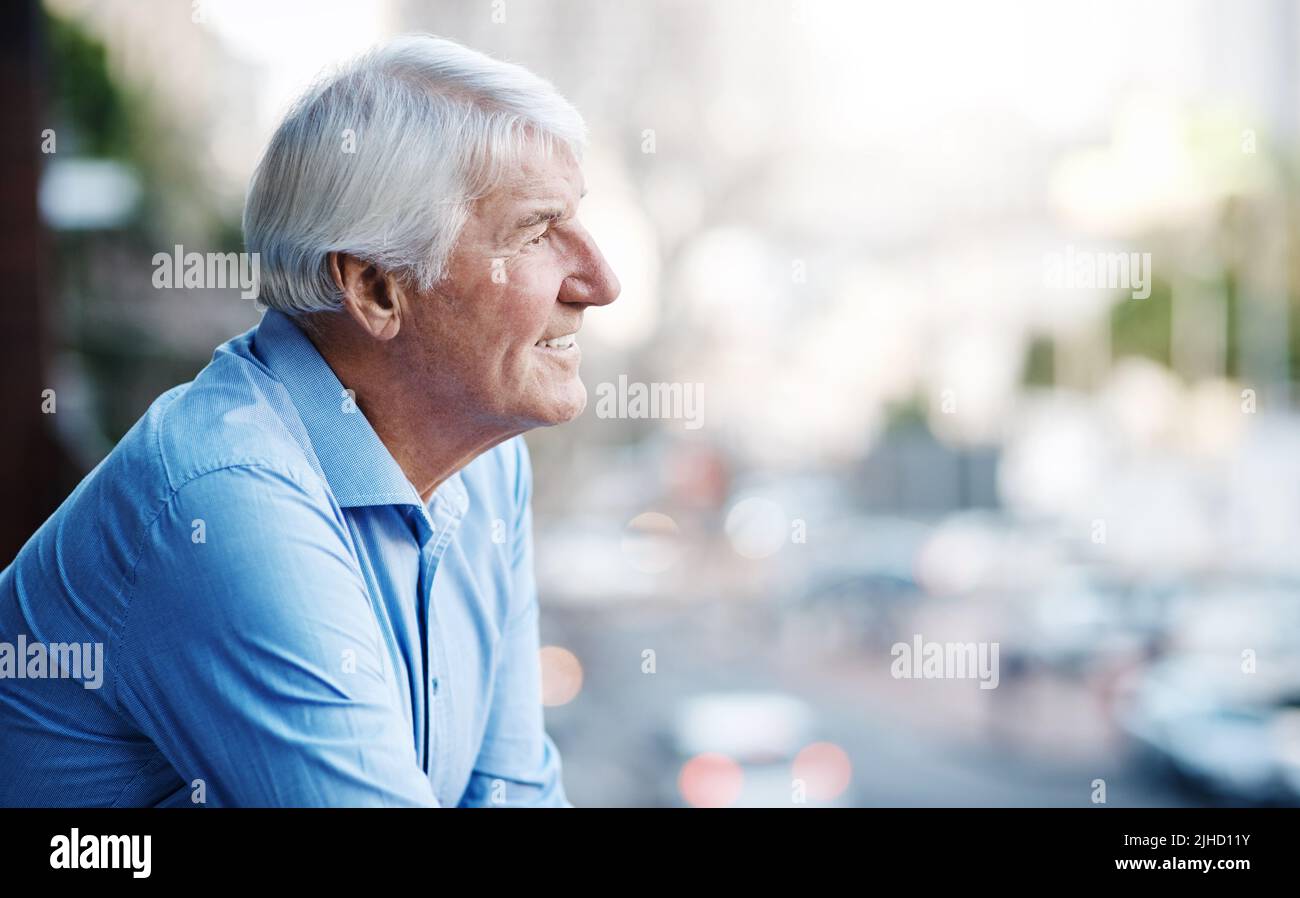 Looking at the city on his break. a senior businessman outside the ...