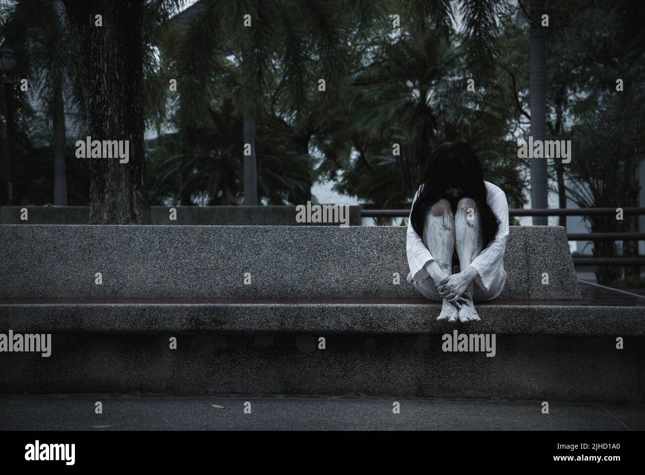 Scary woman ghost horror creepy sitting her hugging his knees, happy ...