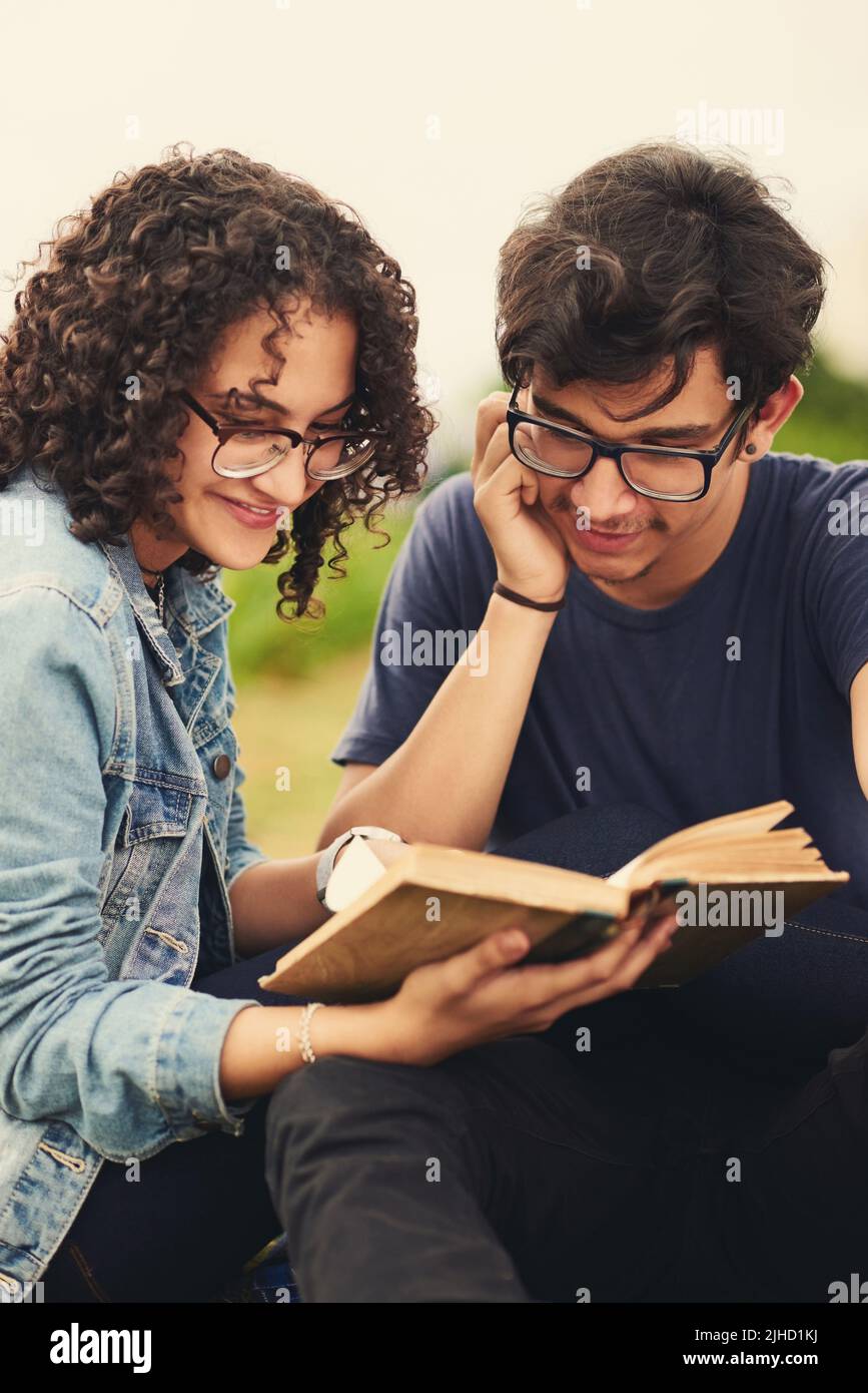 This novel is interesting. a teenage couple reading a book together ...