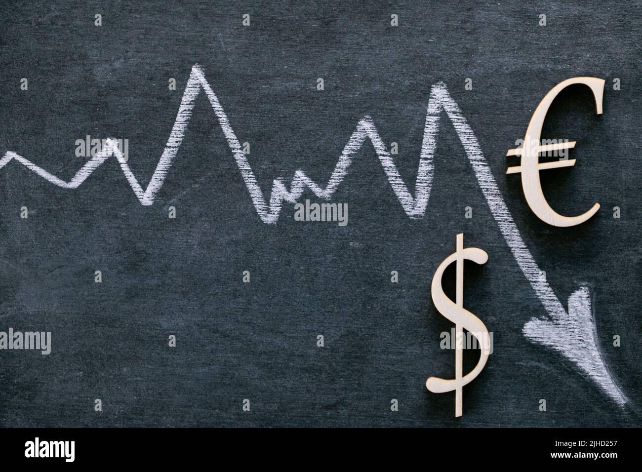 Dollar and Euro inflation.Euro Dollar sign and a down arrow on a black ...