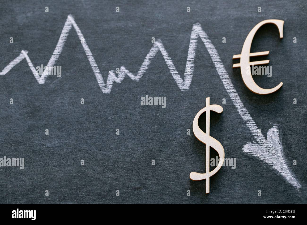 Falling euro currency rate.Dollar and Euro sign and a down arrow on a ...
