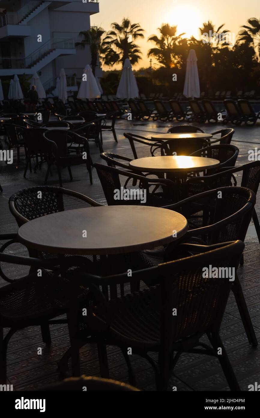 tables in a Turkish street cafe in the early morning light against the ...