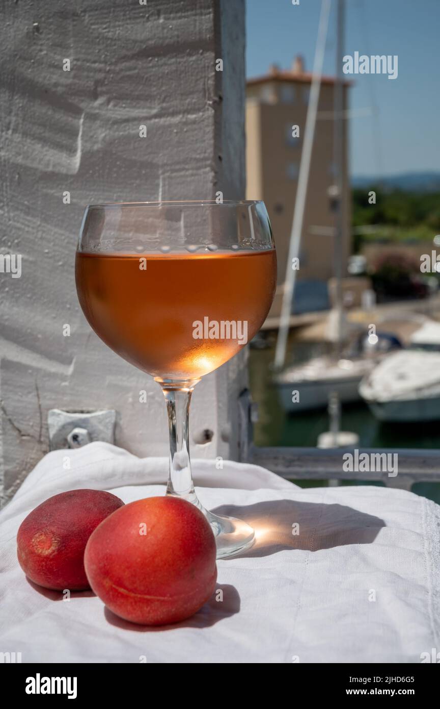 Drinking of cold rose wine from Provence with red apricots and view on ...