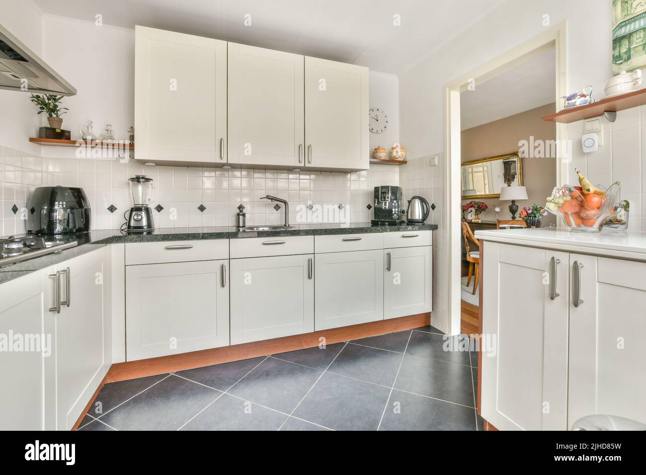 Counter with chairs dividing kitchen with modern furniture from dining ...
