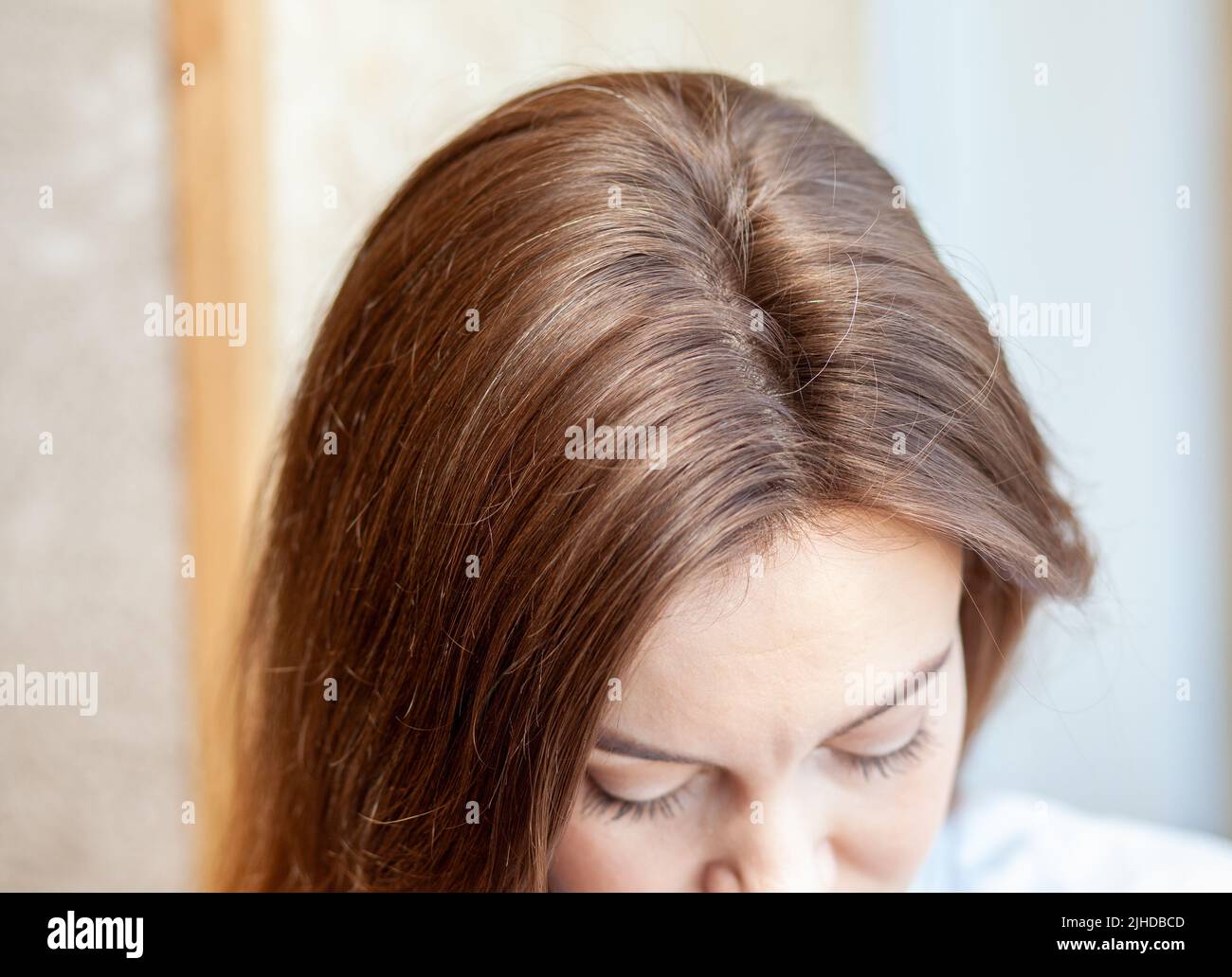 Parting of women's hair on the head. Hair care and care. Closeup of a ...