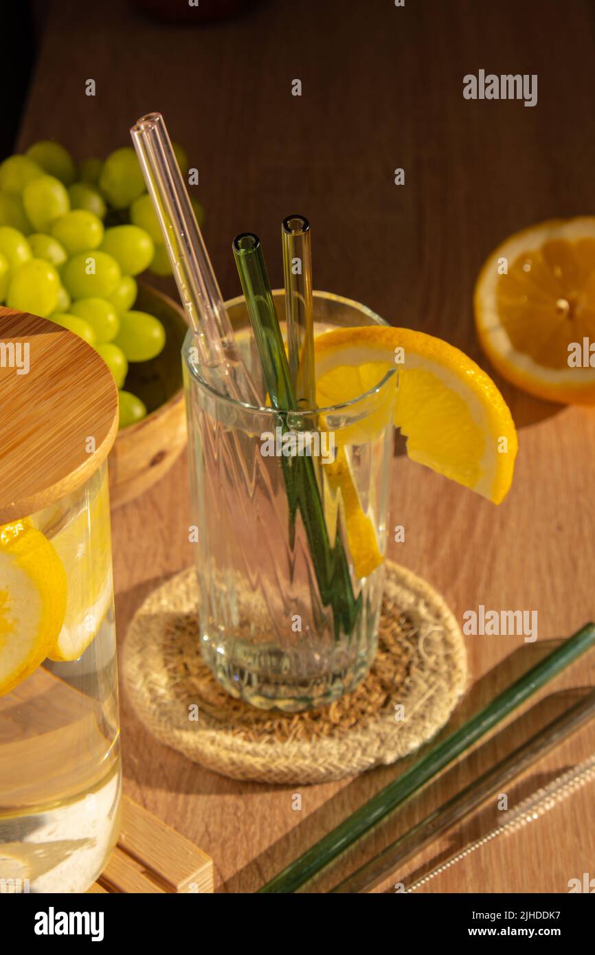 Glass of water with fresh lemon juice with Reusable glass Straws Detox cold tonic water with ...