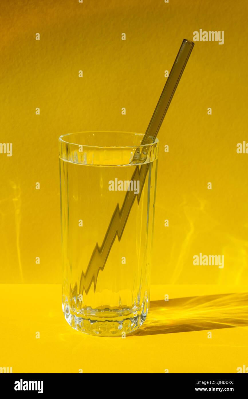 Reusable glass Straws in Glass with water on yellow background Eco ...