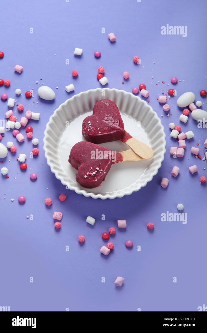 Violet blueberry ice-cream on lilac background. Atmospheric sweet menu ...