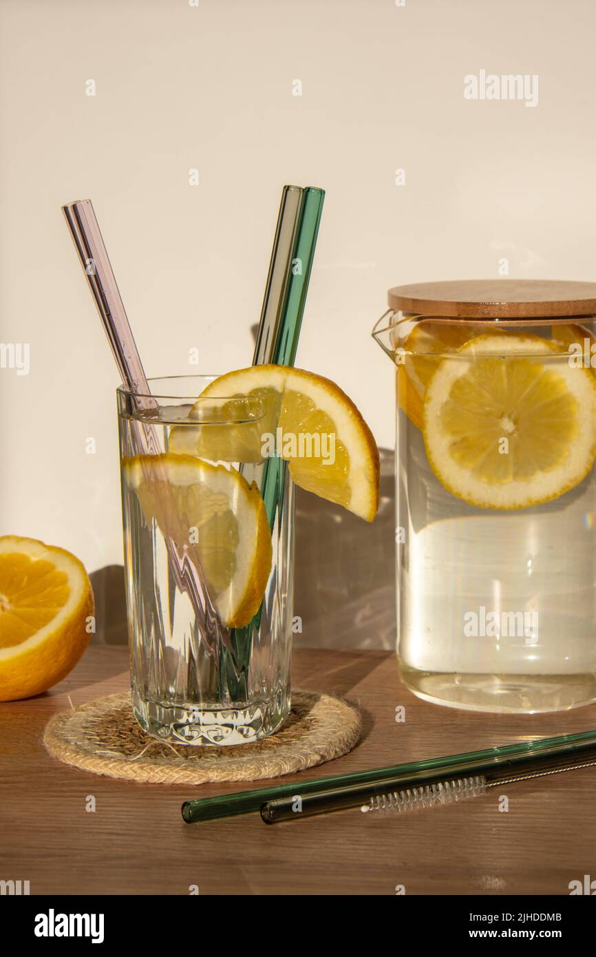 Glass of water with fresh lemon juice with Reusable glass Straws Detox cold tonic water with ...