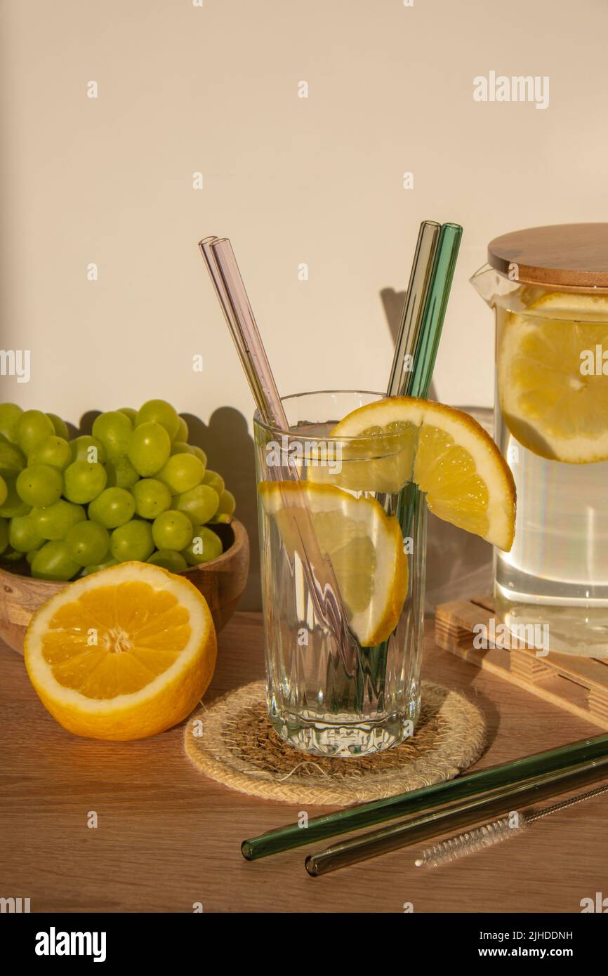 Glass of water with fresh lemon juice with Reusable glass Straws Detox cold tonic water with ...