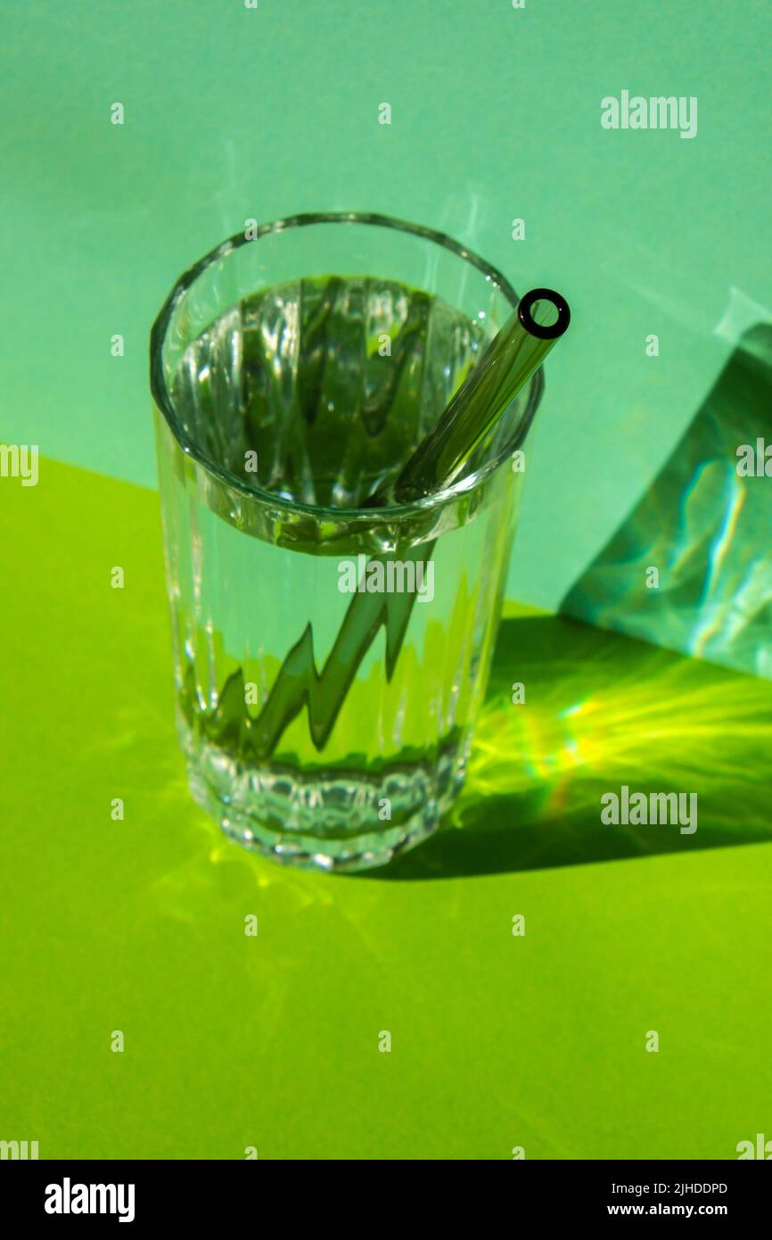 Reusable glass Straws in Glass with water on green background Eco ...