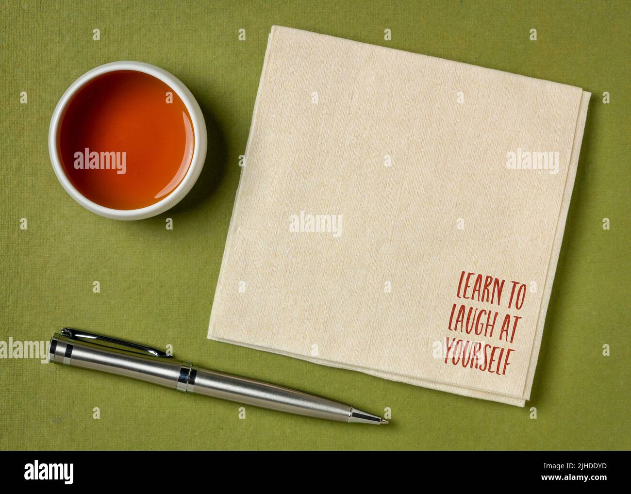 learn to laugh at yourself inspirational note on a napkin with a copy ...