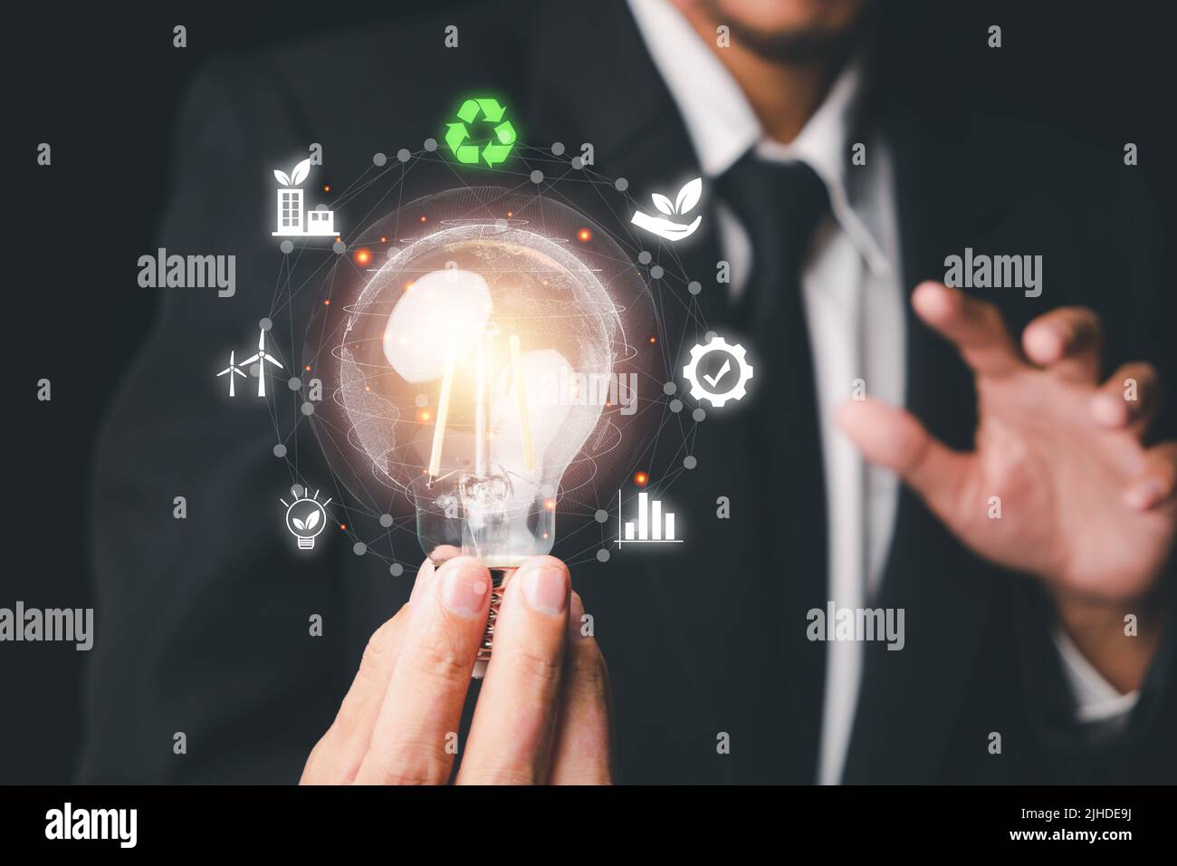 Businessman hand holding light bulb with esg icon on virtual screen ...