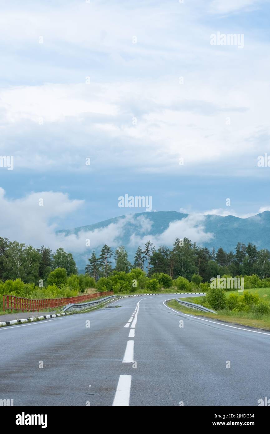 Empty road. Speedway without cars in mountains amid pine forests ...