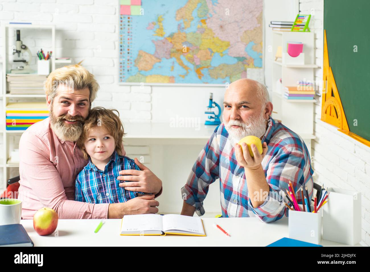Grandfather father and son, men in different ages ready to study. Happy ...