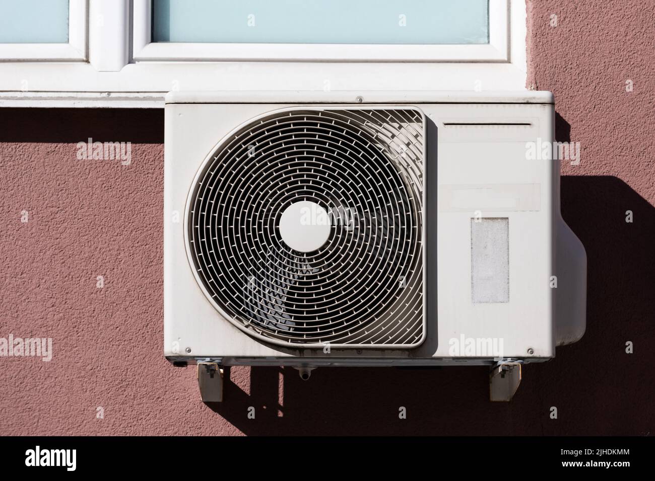 outdoor unit of a domestic air conditioner with a fan outside the ...