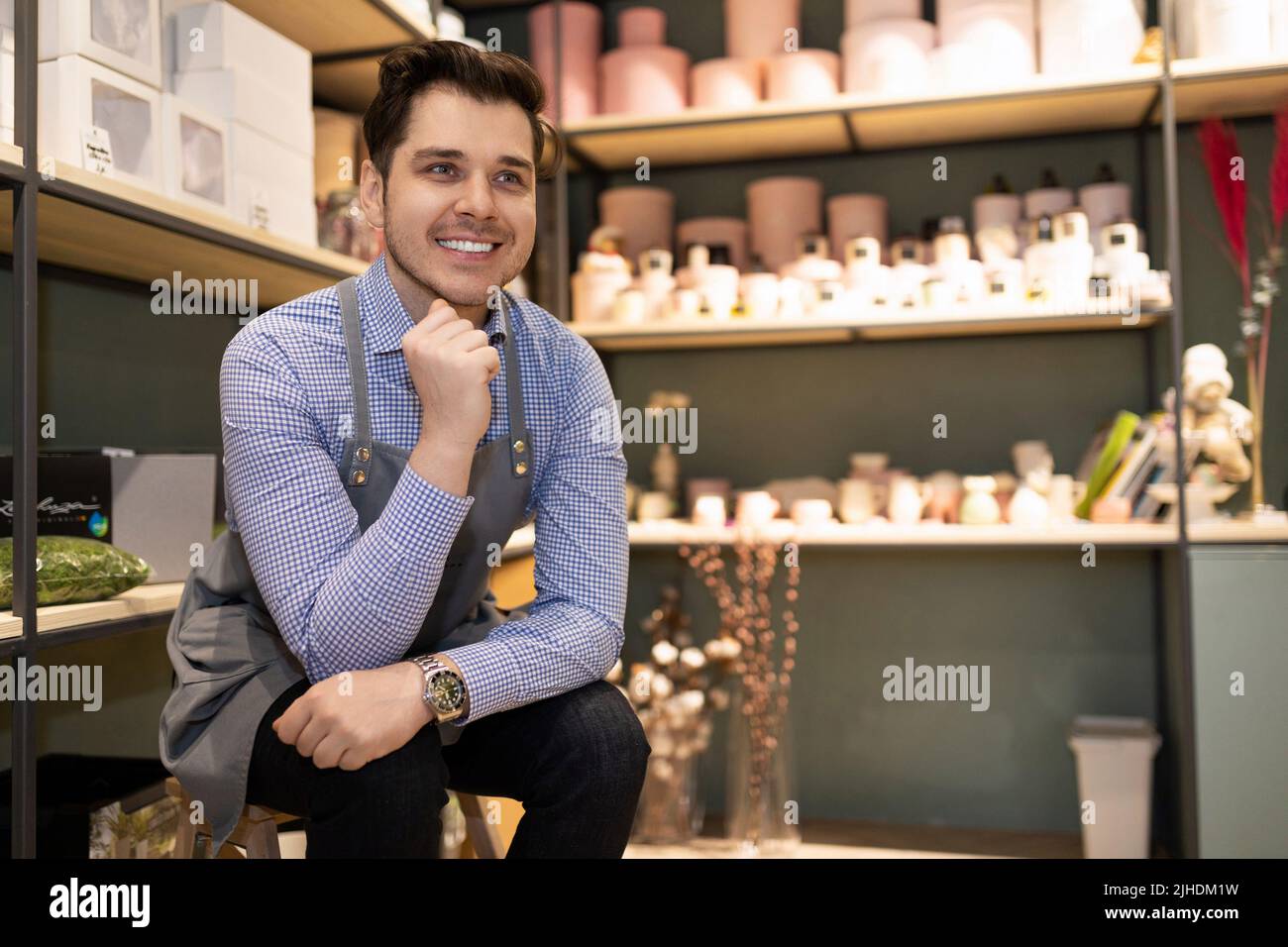 flower shop employee waiting for customers at the beginning of the day ...