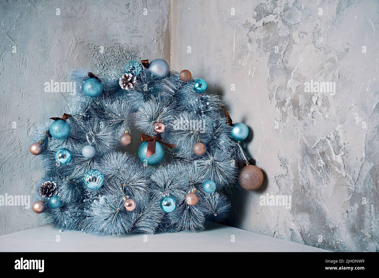 Christmas light blue wreath on a concrete wall background Stock Photo ...