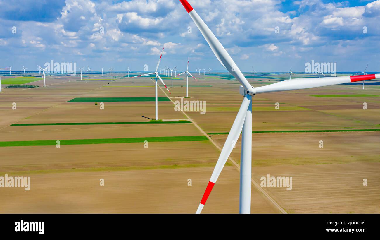 Above view on farm of large wind power turbines are standing among ...