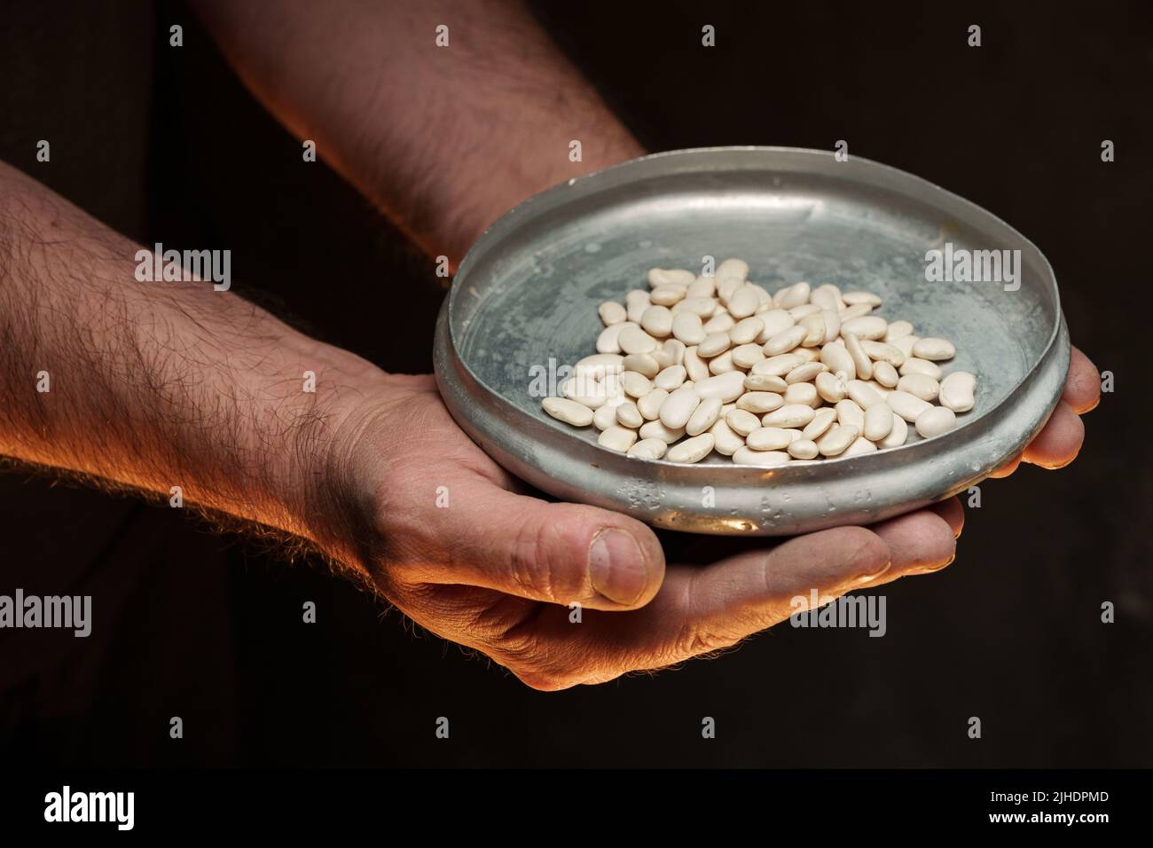 Male hands holding grains of dry kidney beans on dark background Stock ...