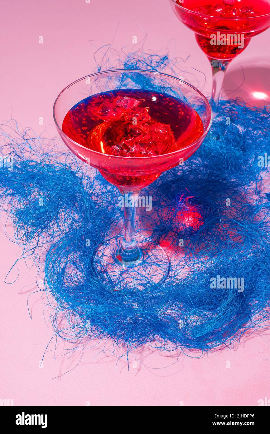 Pink summer cocktails on color background close up Stock Photo - Alamy