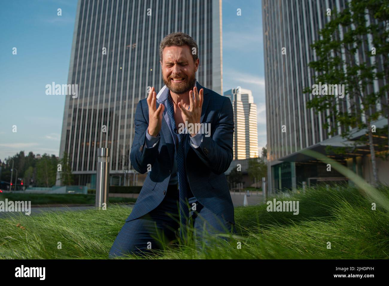 Business man lost in depression crying sitting on street suffering ...