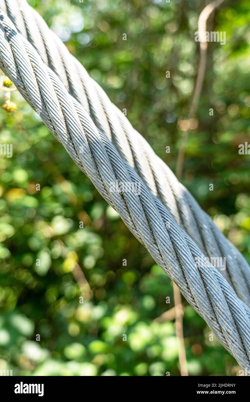 Twisted steel rope suspension bridge in nature close-up Stock Photo - Alamy
