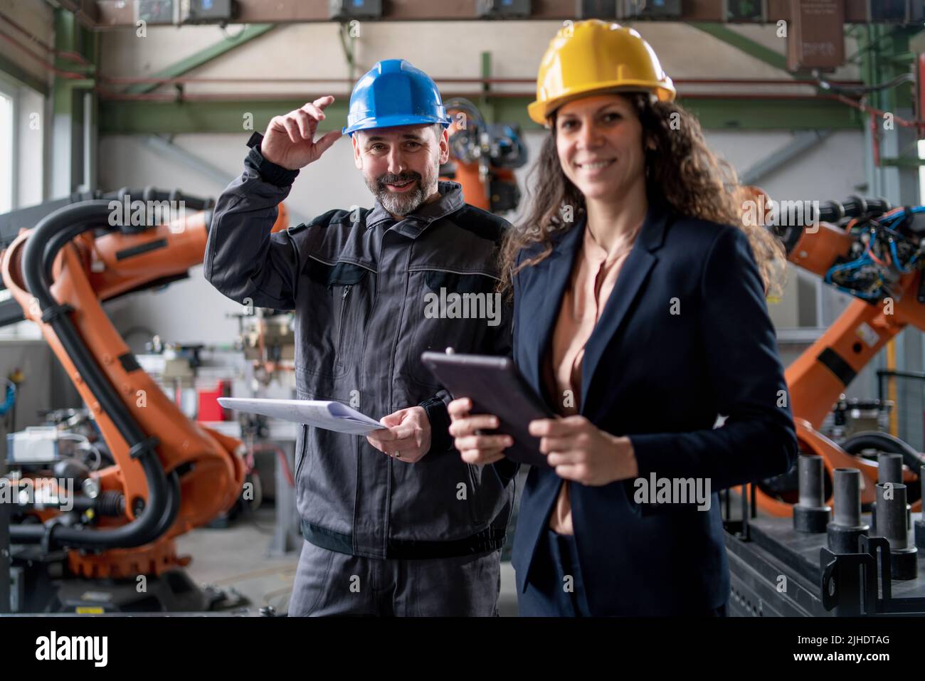 Female engineering manager and mechanic worker doing routine check up ...