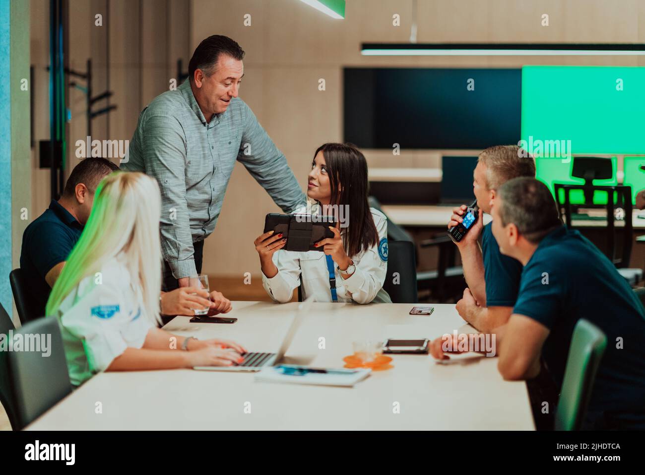 Group of security guards sitting and having briefing In the system ...