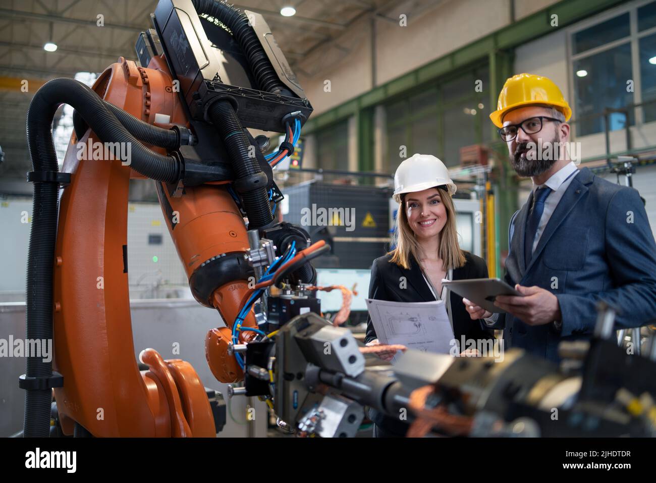 Female engineering manager and mechanic worker doing routine check up ...