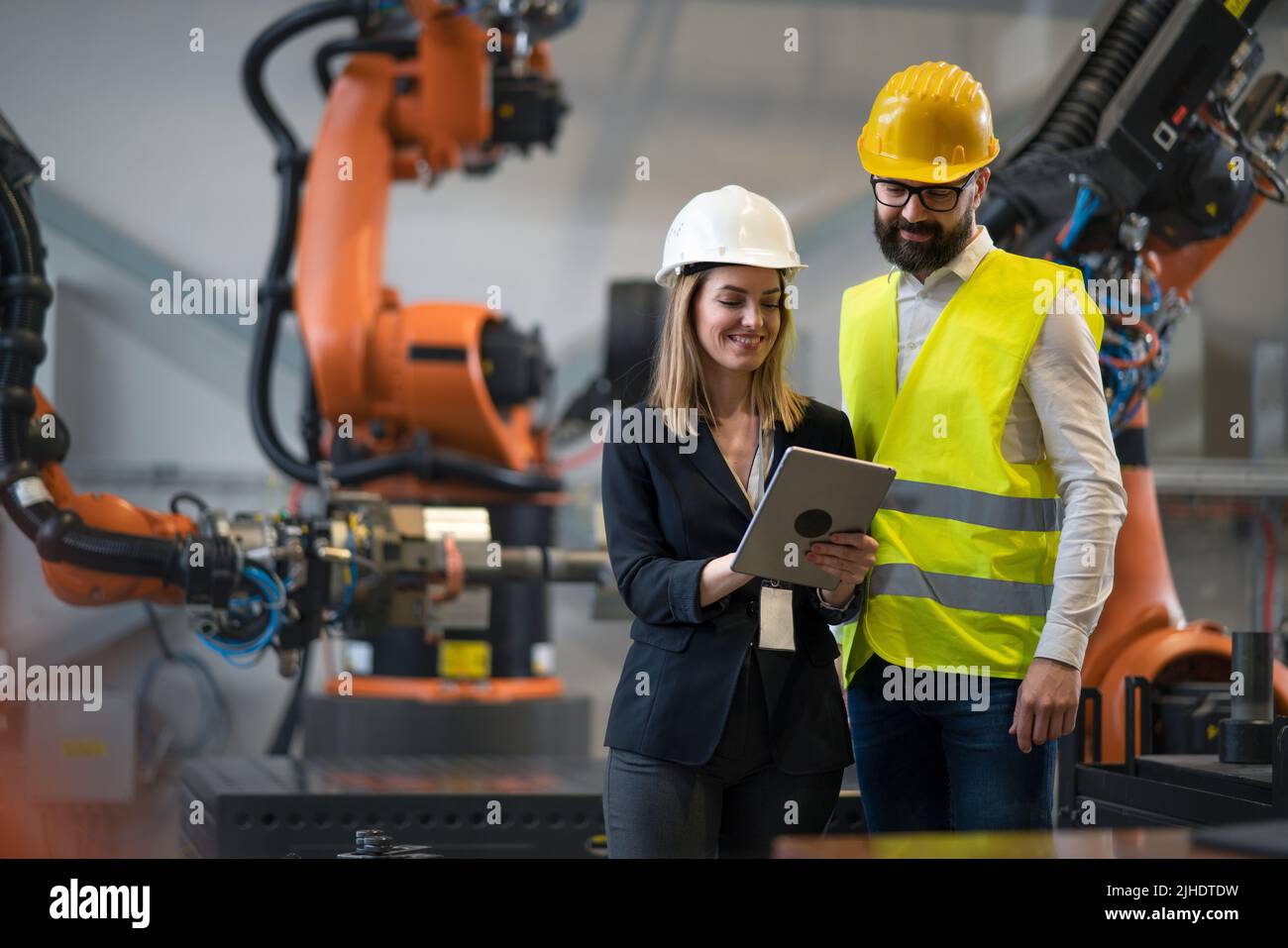 Chief engineer and project manager in modern industrial factory with ...