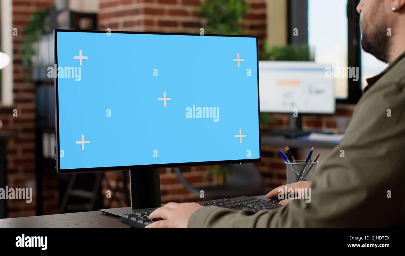 Businessman working on monitor with greenscreen template, using ...