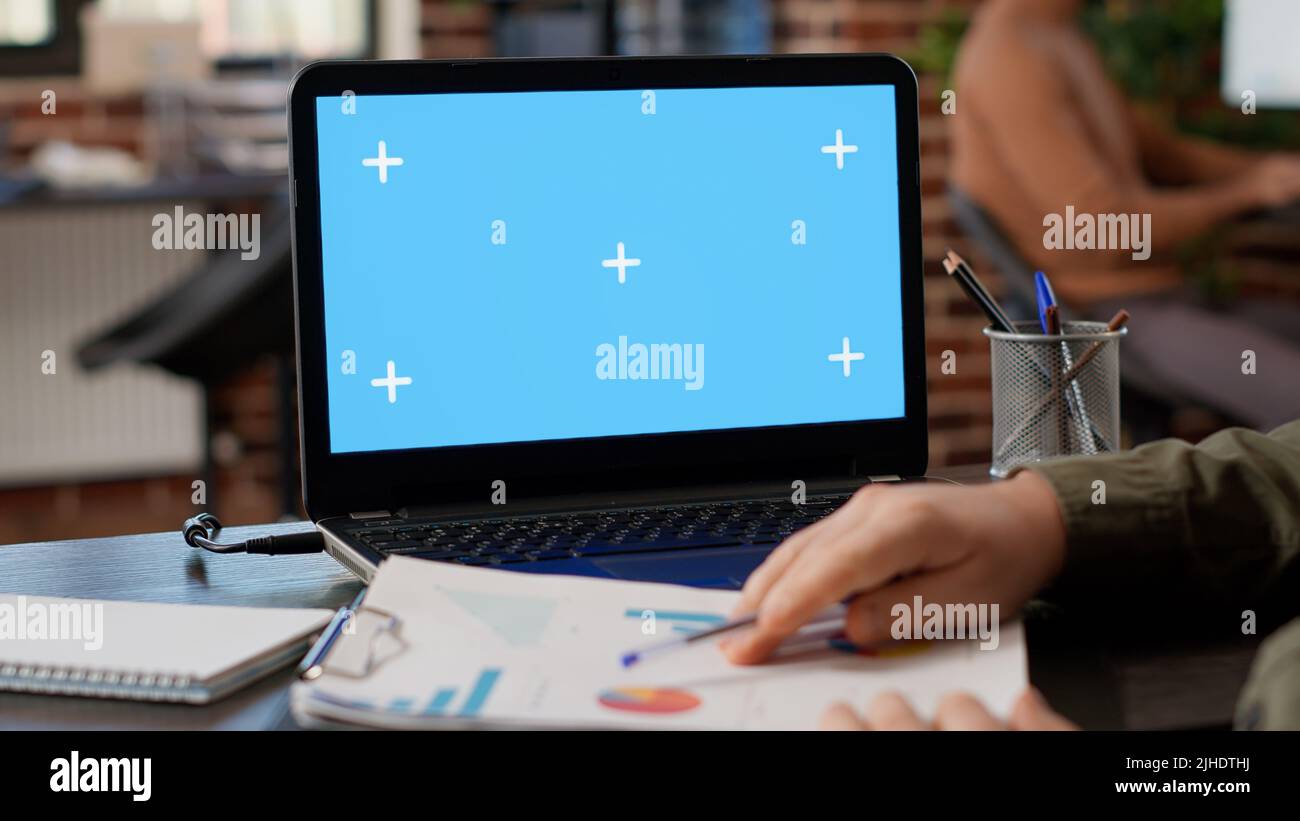 Male Freelancer Analyzing Business Charts And Greenscreen On Laptop