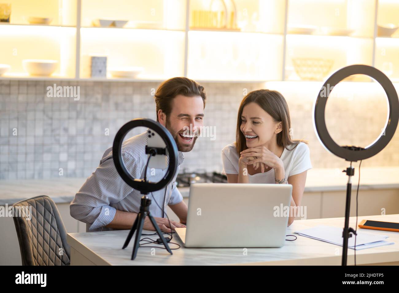 Two vloggers having online tutorial and looking involved Stock Photo ...