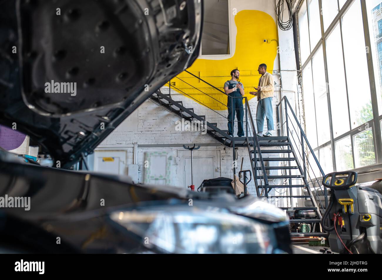 Two people standing on the stairs in the garage Stock Photo - Alamy