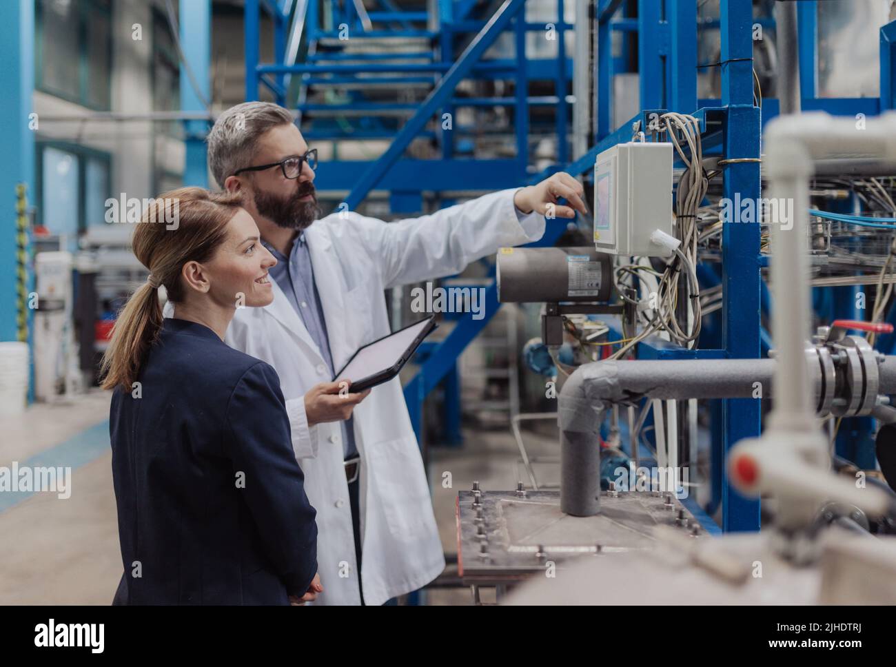 Engineering managers with tablet doing routine check up in industrial ...