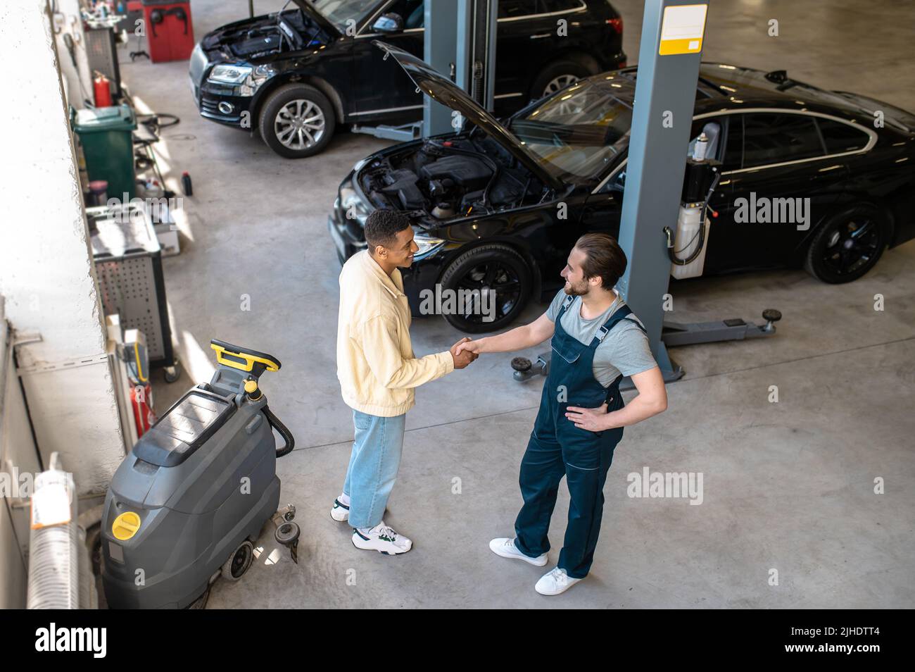 Maintenance engineer talking to the client in the garage Stock Photo ...