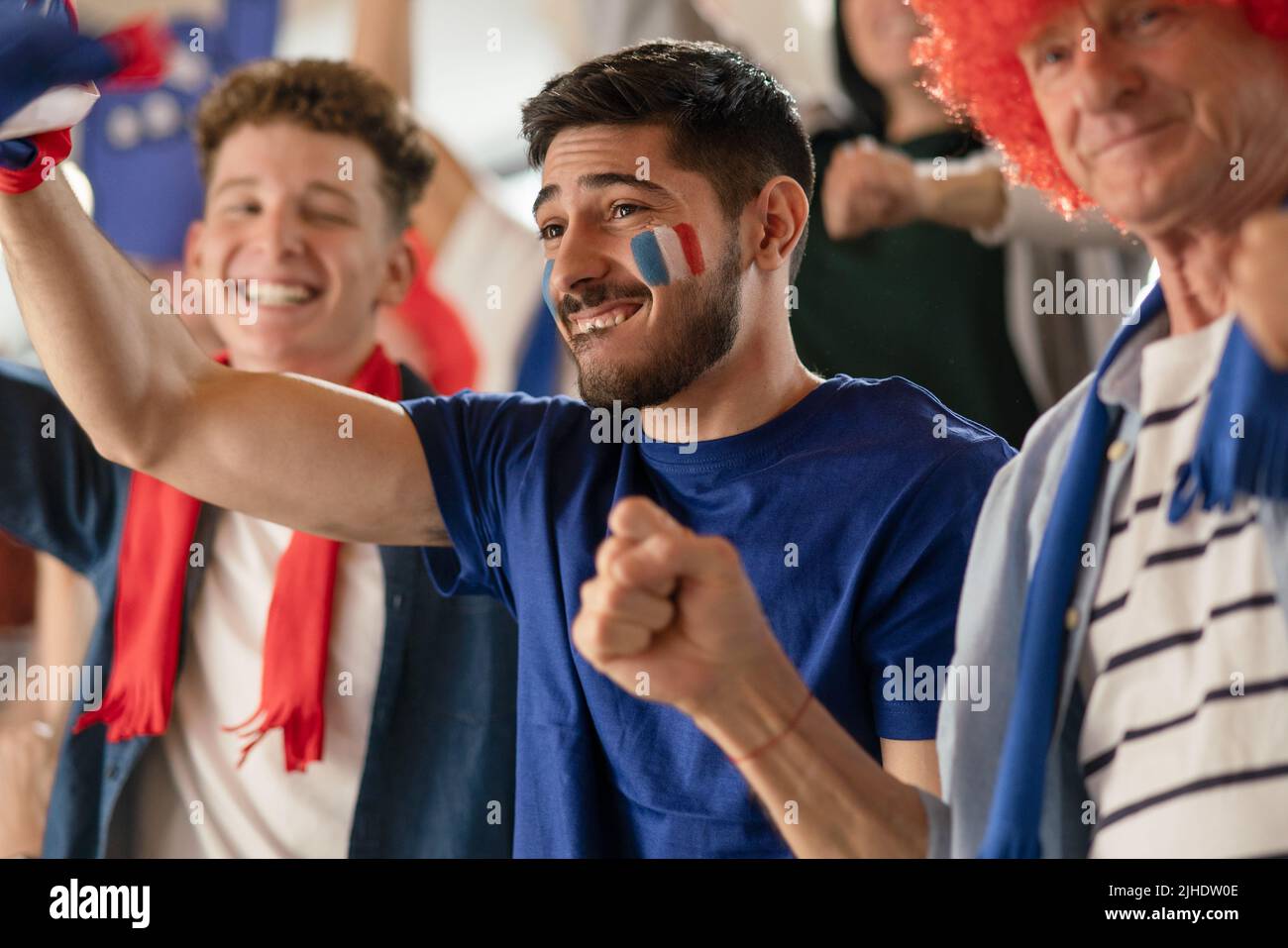 Excited football fans supporting French national team in live soccer ...