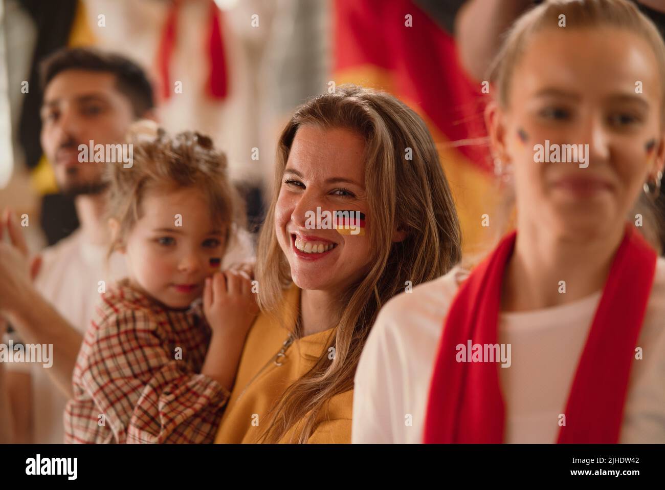 Excited football fans, mother with little daughter, supproting German ...