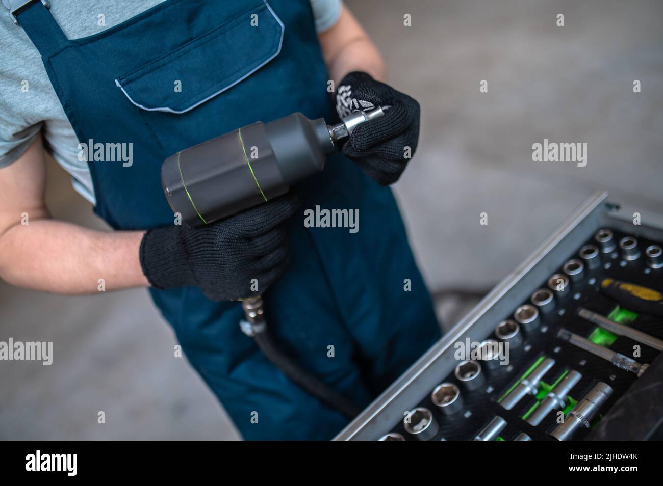 Close up picture of a technician with a tool in hands Stock Photo - Alamy