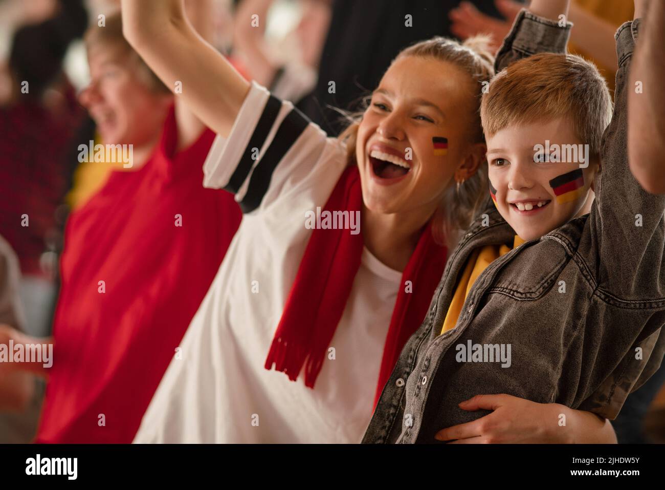 Young German football fans celebrating their team's victory at stadium ...