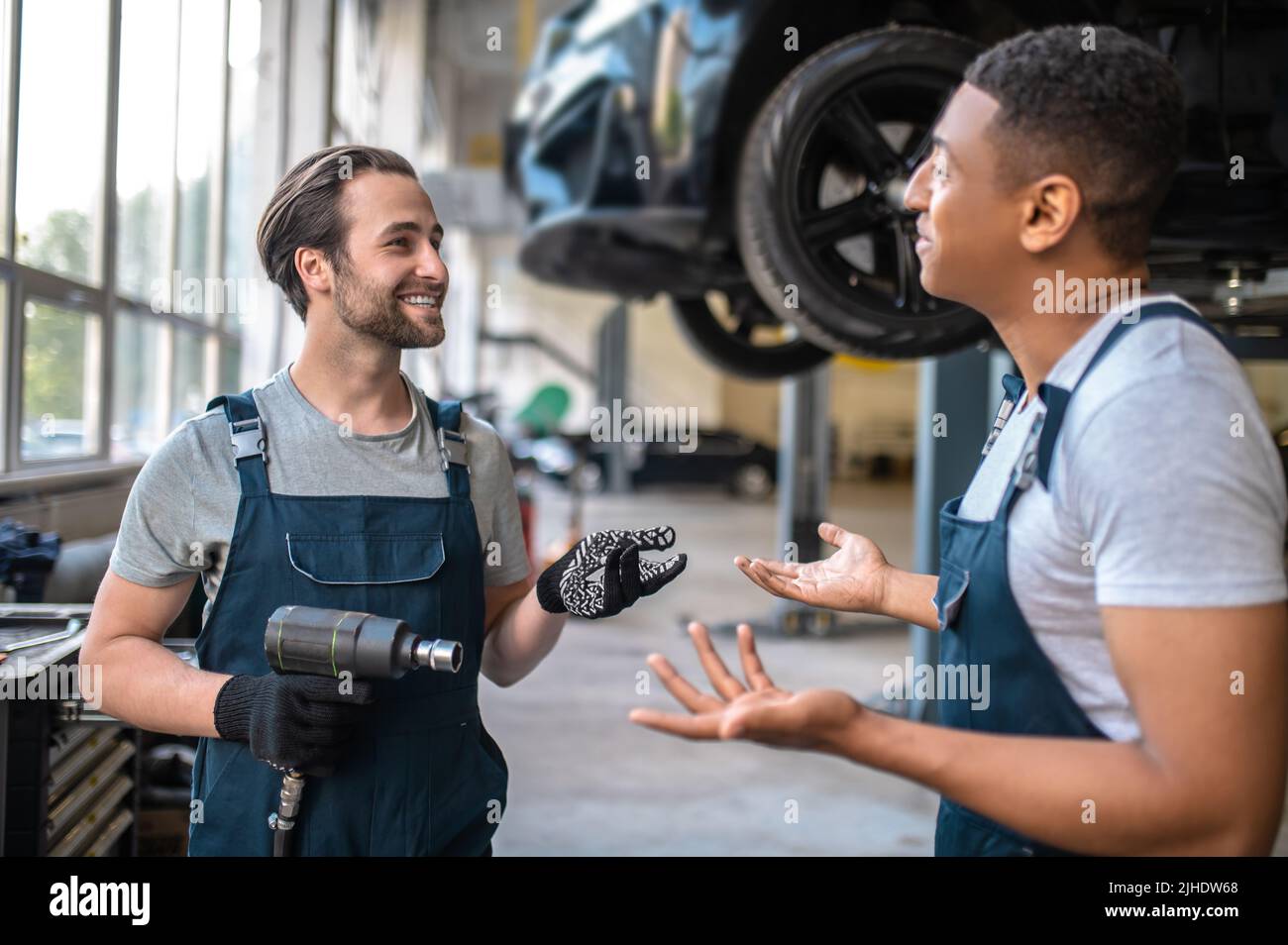 Two maintenance engineers at work in the garage Stock Photo - Alamy