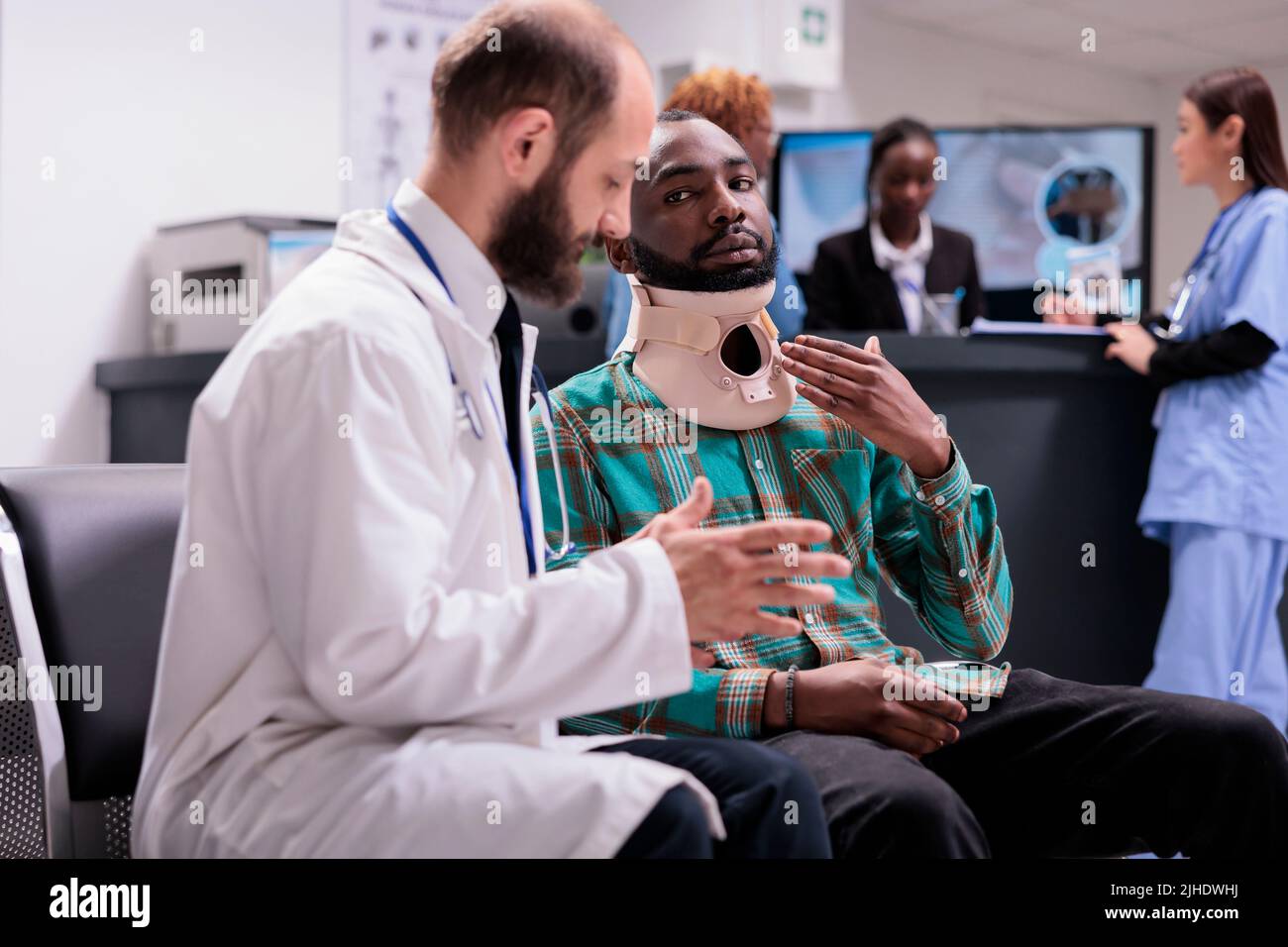 Physician consulting hurt person with neck collar foam, sitting in ...
