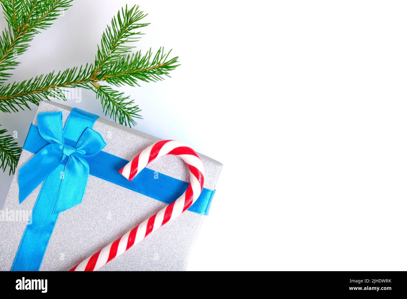 Christmas gift box tied with blue ribbon with bow with green Christmas ...