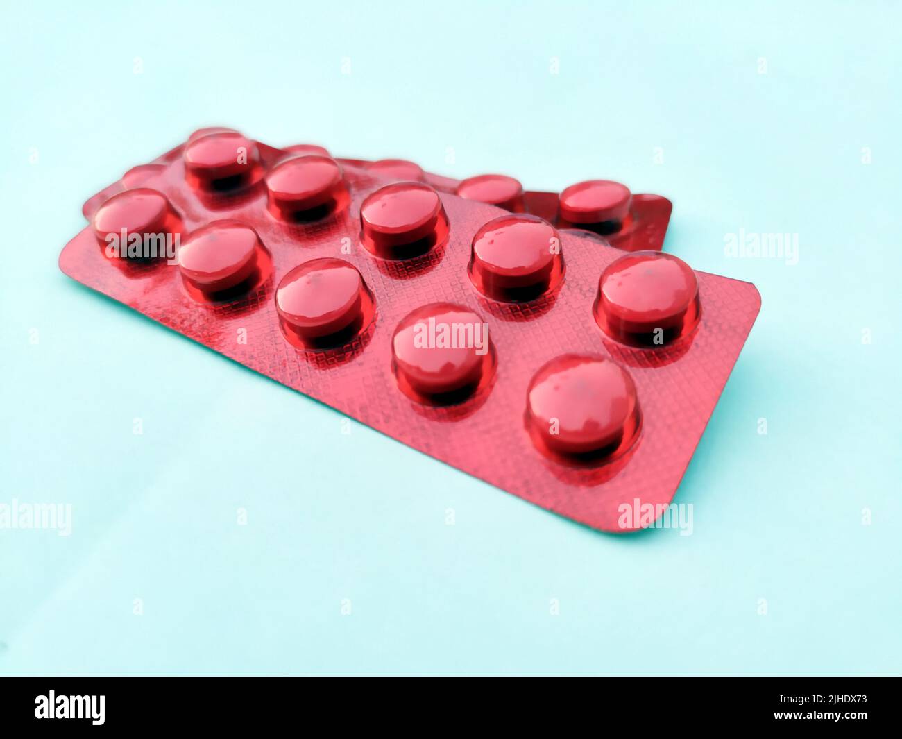 medecine red tablets isolated on white backgroun Stock Photo - Alamy